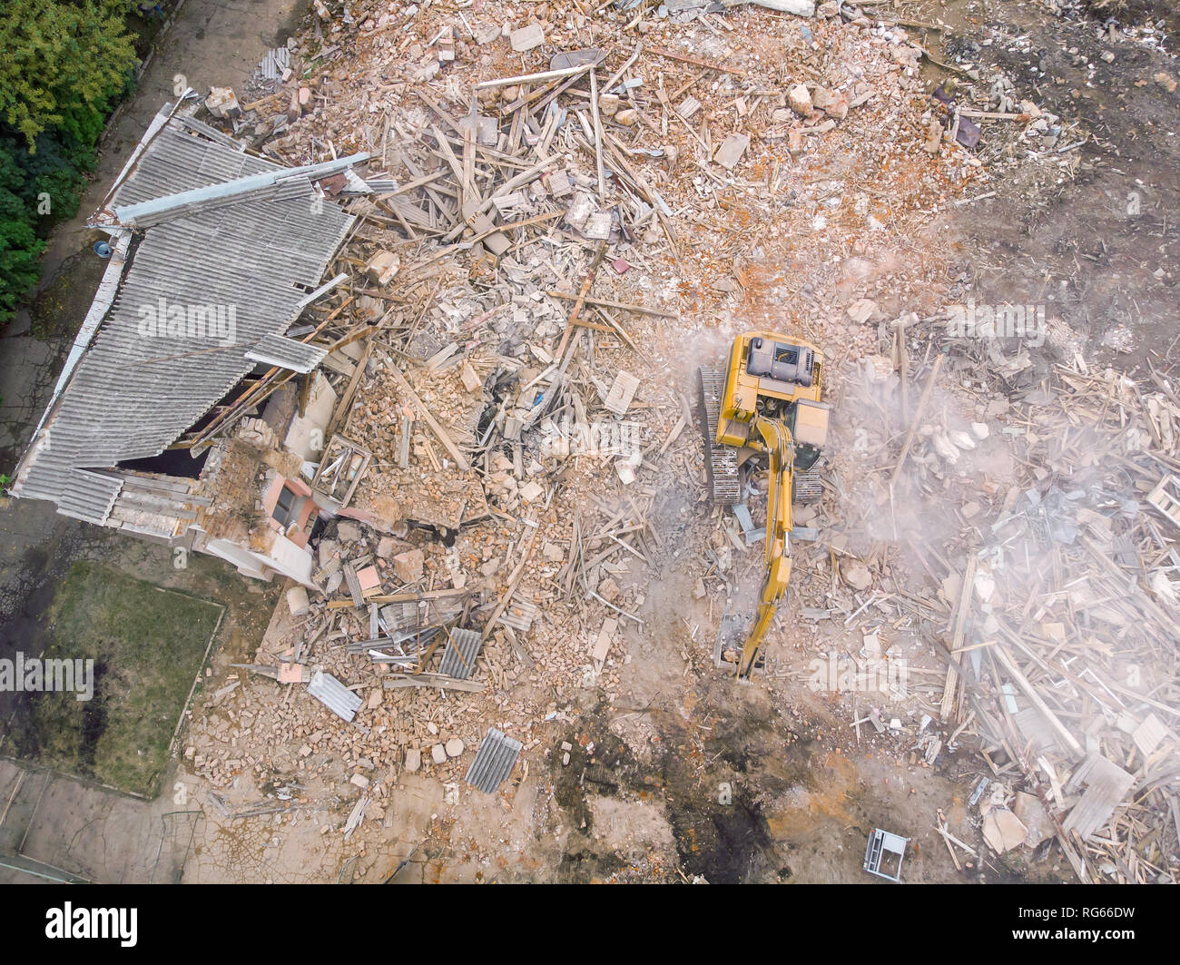 aerial view of demolition site with ruined old building and yellow ...