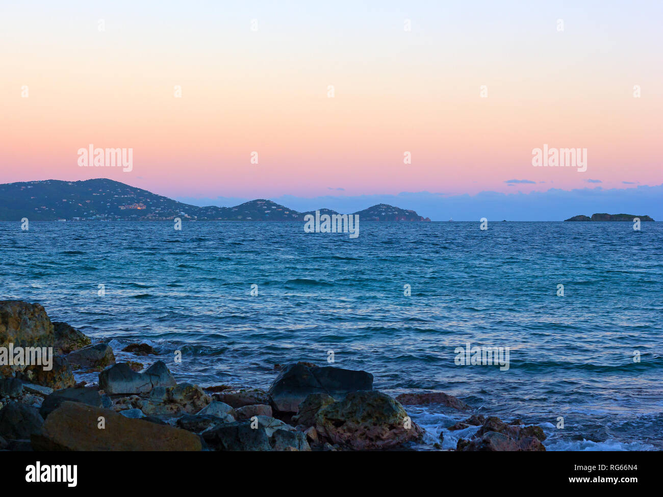 Sunset over Caribbean Sea with Virgin Islands US on horizon. Sun goes ...