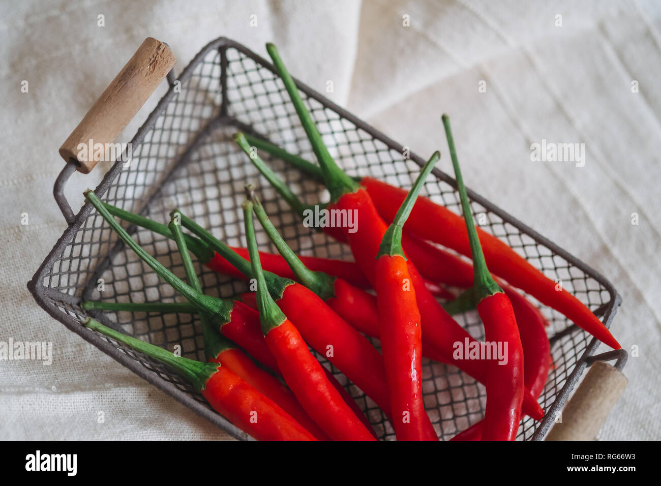 Red chili pepper in wire mesh basket Stock Photo - Alamy
