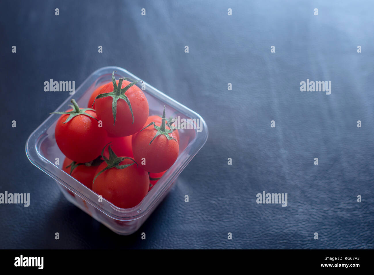 Red tomatoes on plastic box Stock Photo - Alamy