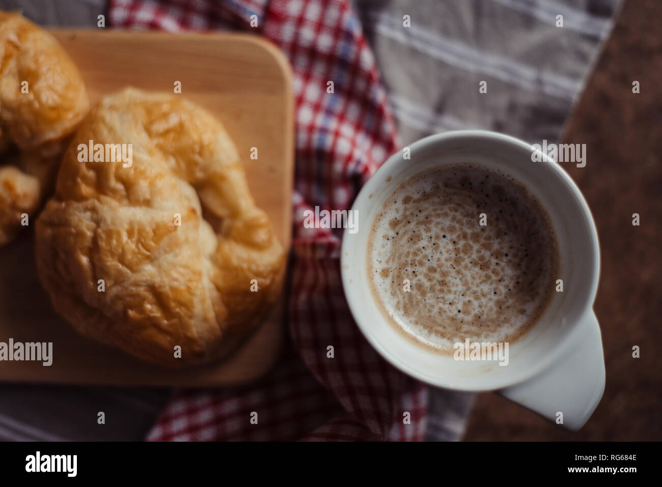 Croissant with coffee cup in cozy morning Stock Photo - Alamy