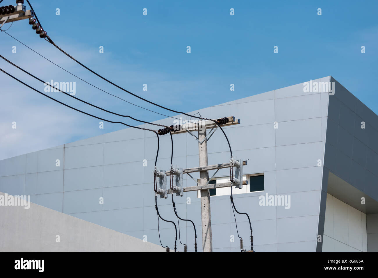 Electric line with building Stock Photo - Alamy