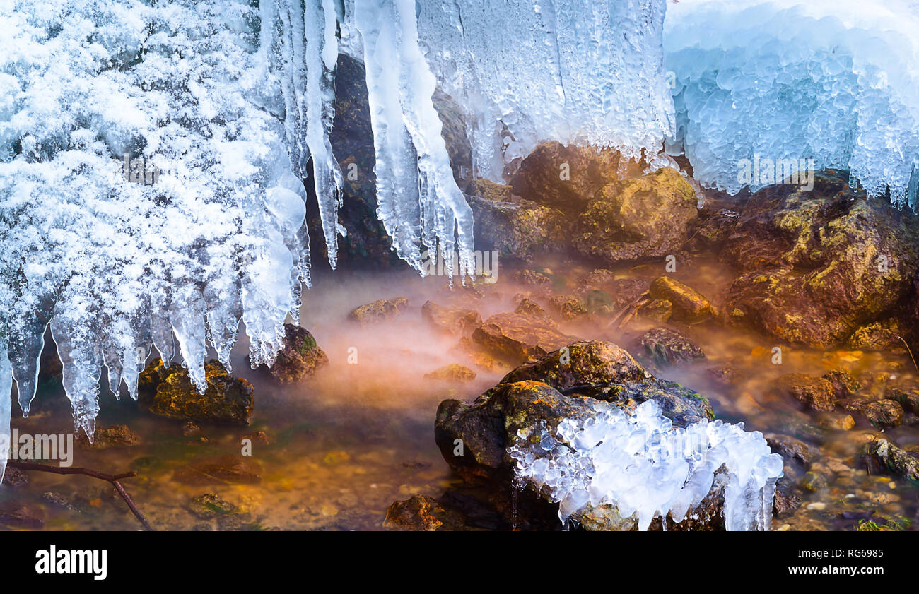 Cold blue in combination with warm golden stones, drops of ice on a ...