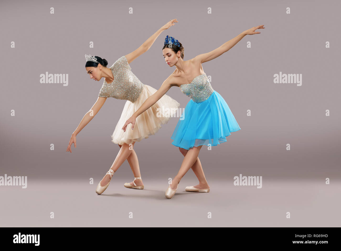 Side view of two professional dancers in dresses, ballet shoes and ...