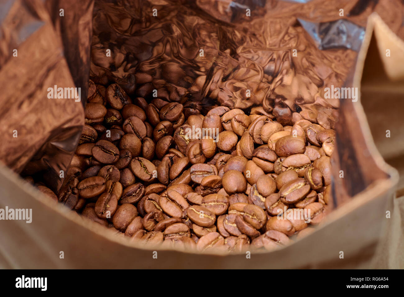 coffee beans in a package large view in macro big Stock Photo - Alamy