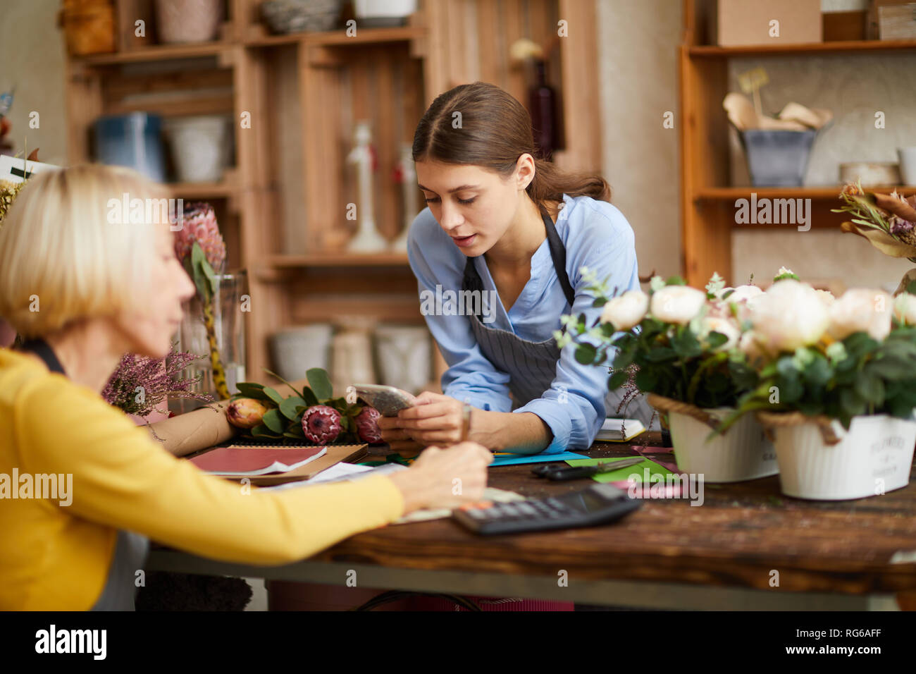 Two Woman Managing Flower Shop Stock Photo - Alamy