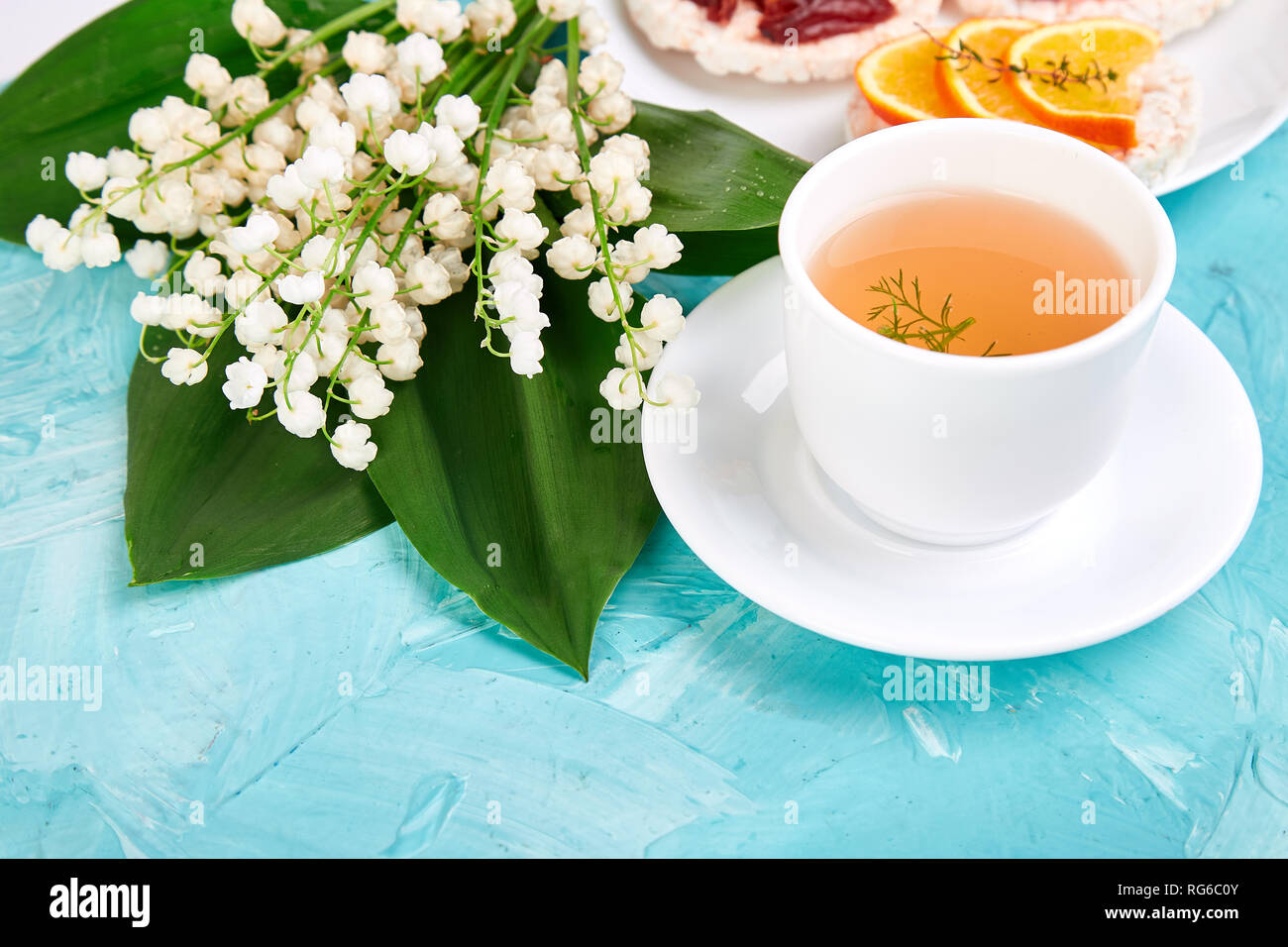 Breakfast - tea, rice crispbread with fresh fruits on blue background ...