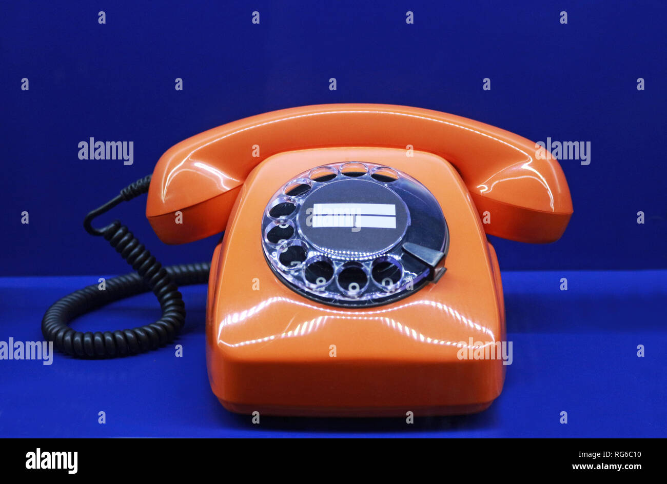 orange colored seventies retro telephone with dial Stock Photo - Alamy