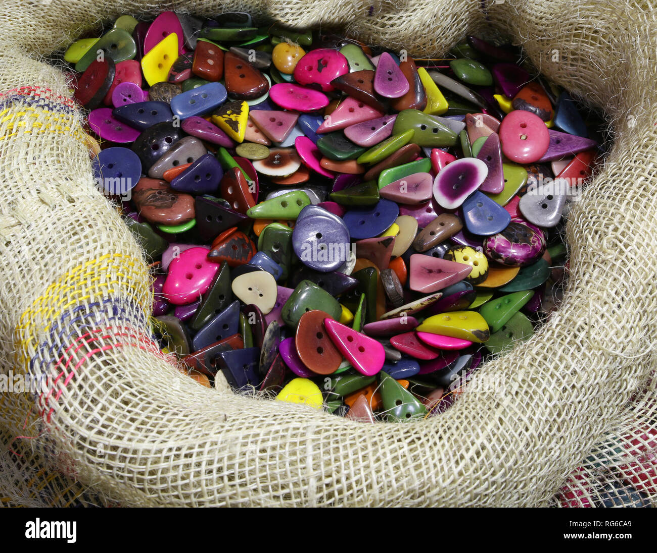 jute bag full of buttons made with colored palm seeds dried naturally ...