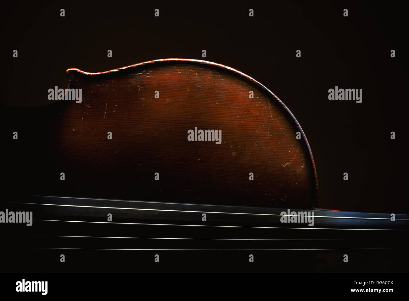 Part of an old dusty cello, details of old wood and strings ...