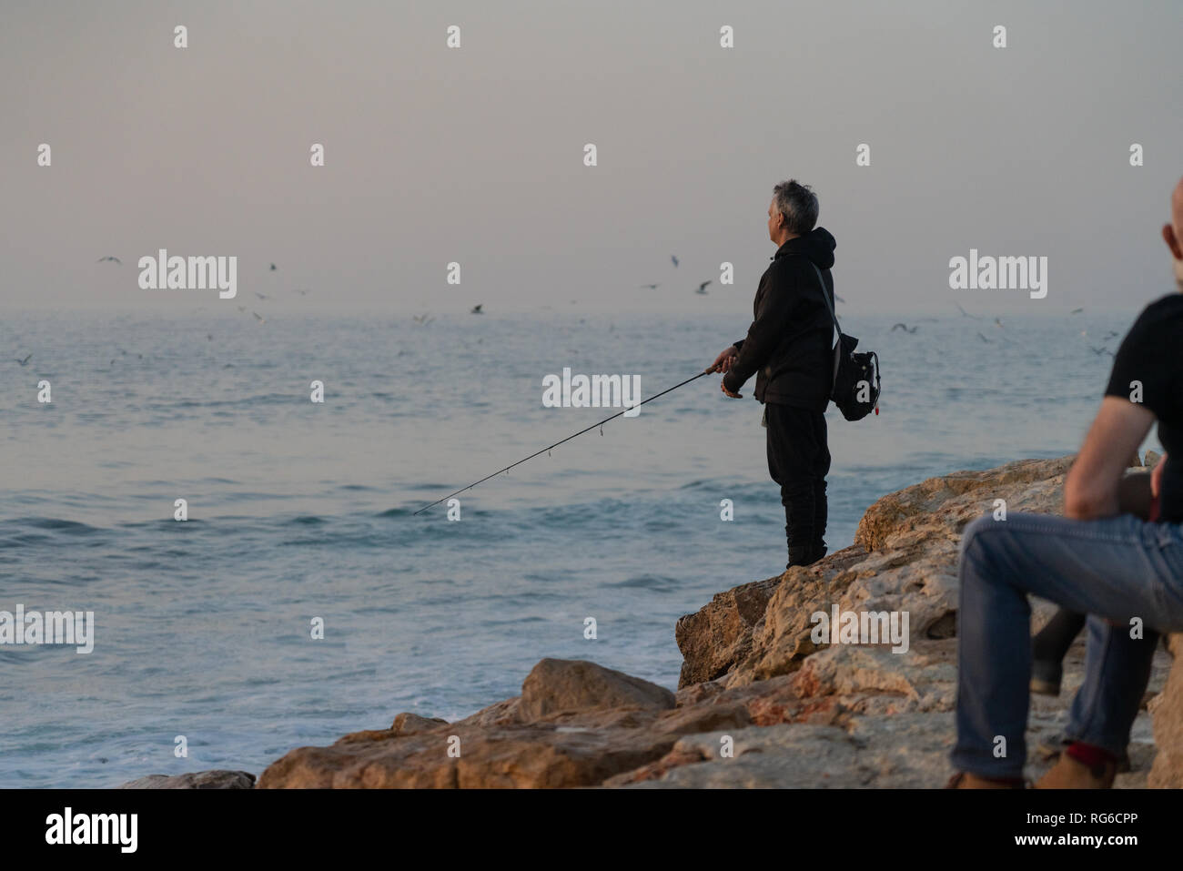 Fishing on the Tel Aviv boardwalk Stock Photo - Alamy