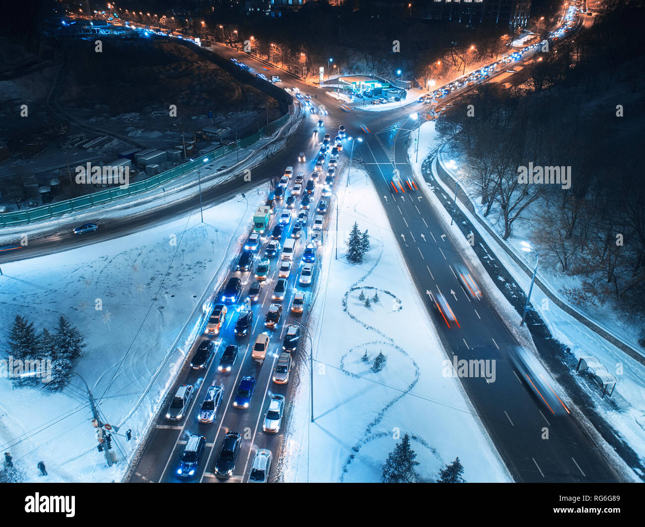Aerial view of road in the city at night in winter. Top view of traffic ...