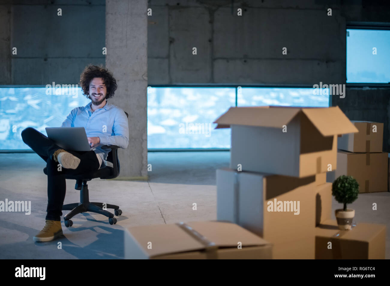 young male architect on construction site checking documents and ...