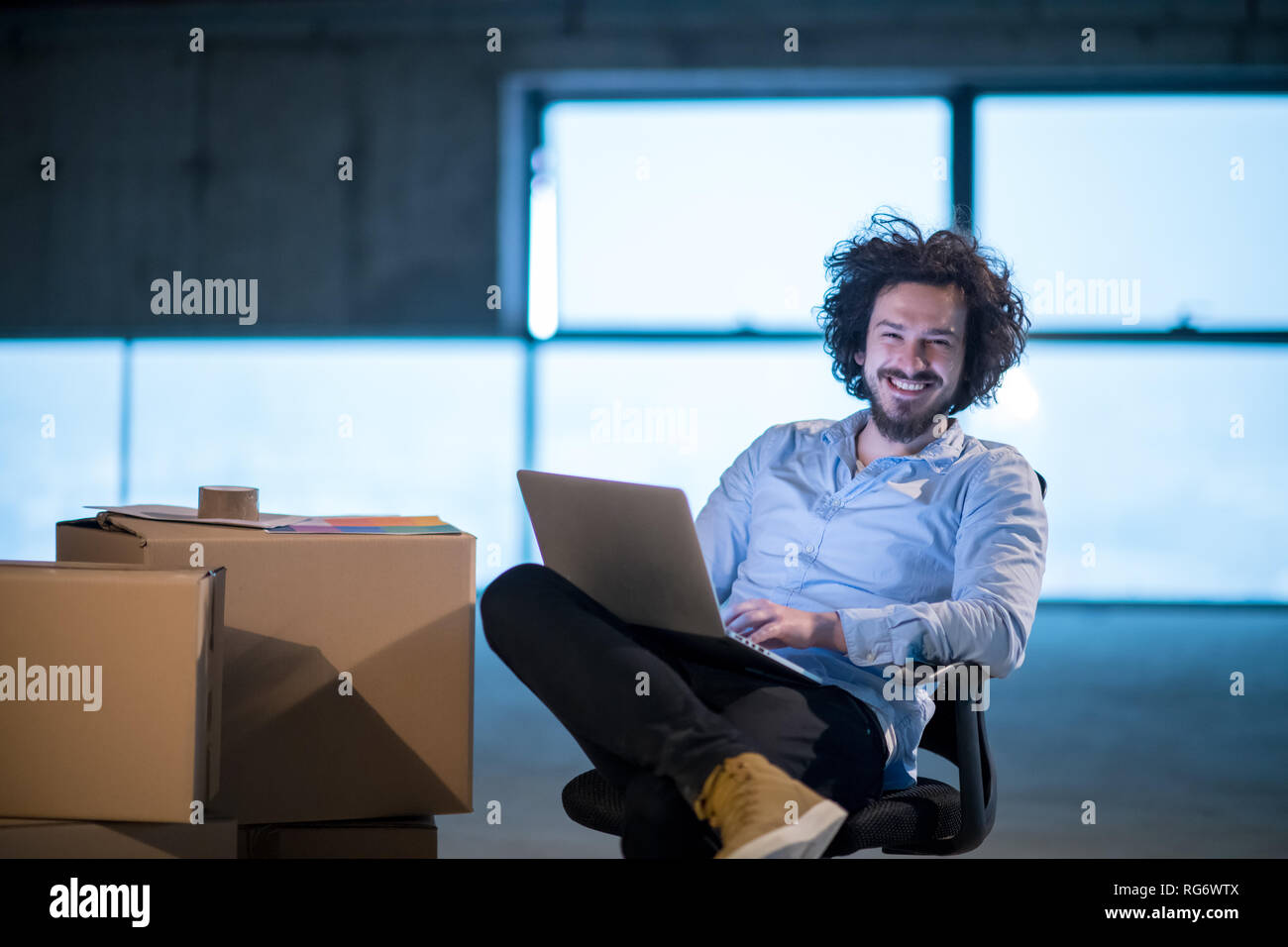 young male architect on construction site checking documents and ...