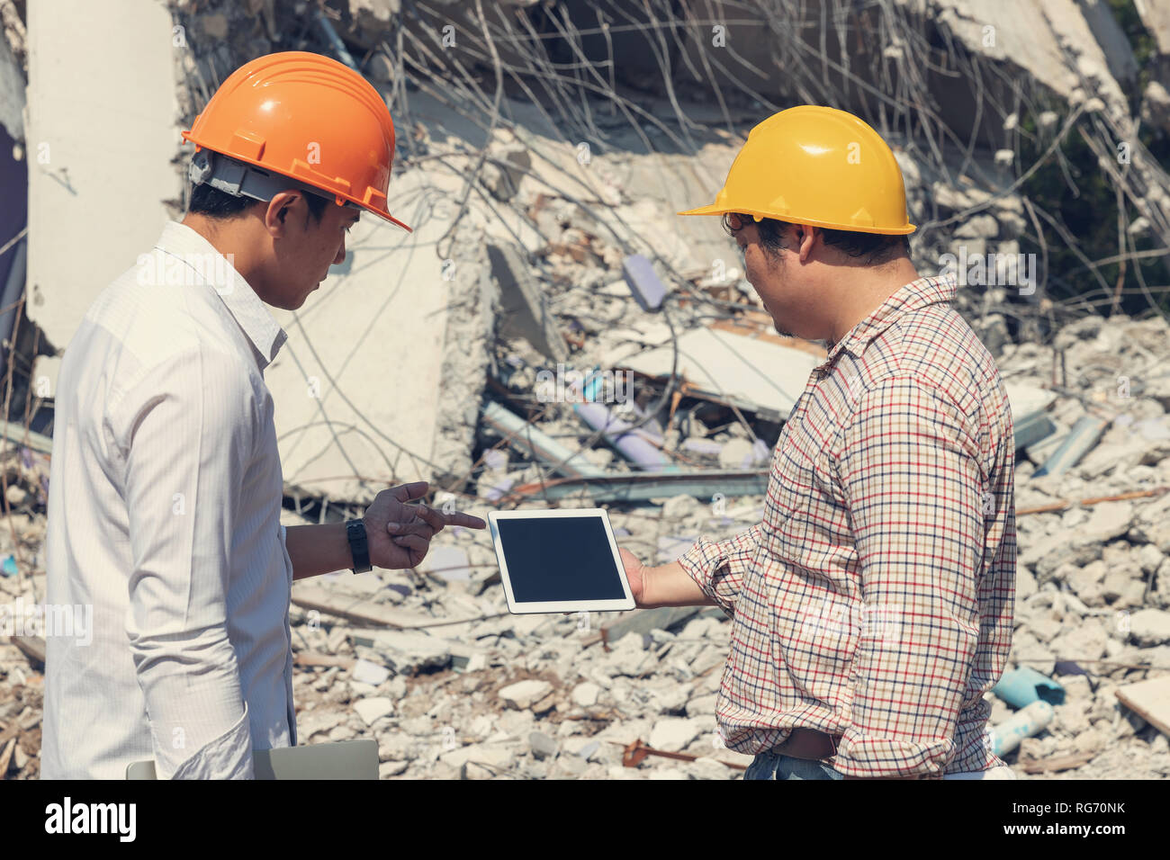 Engineer architect and worker operation control demolish old building ...