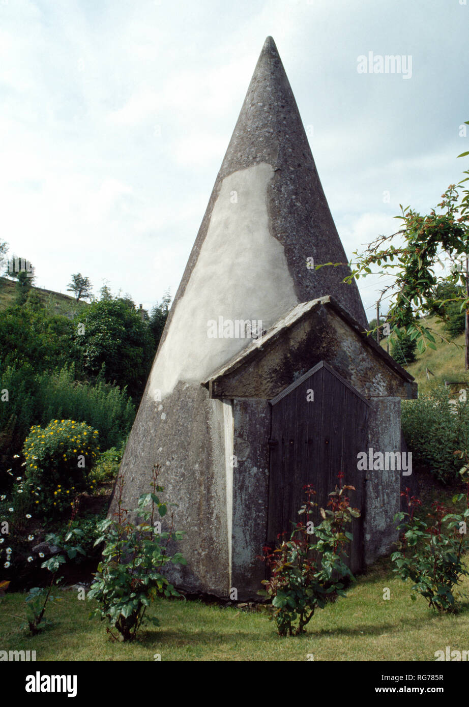 Unusual cone shaped concrete garden shed Stock Photo - Alamy