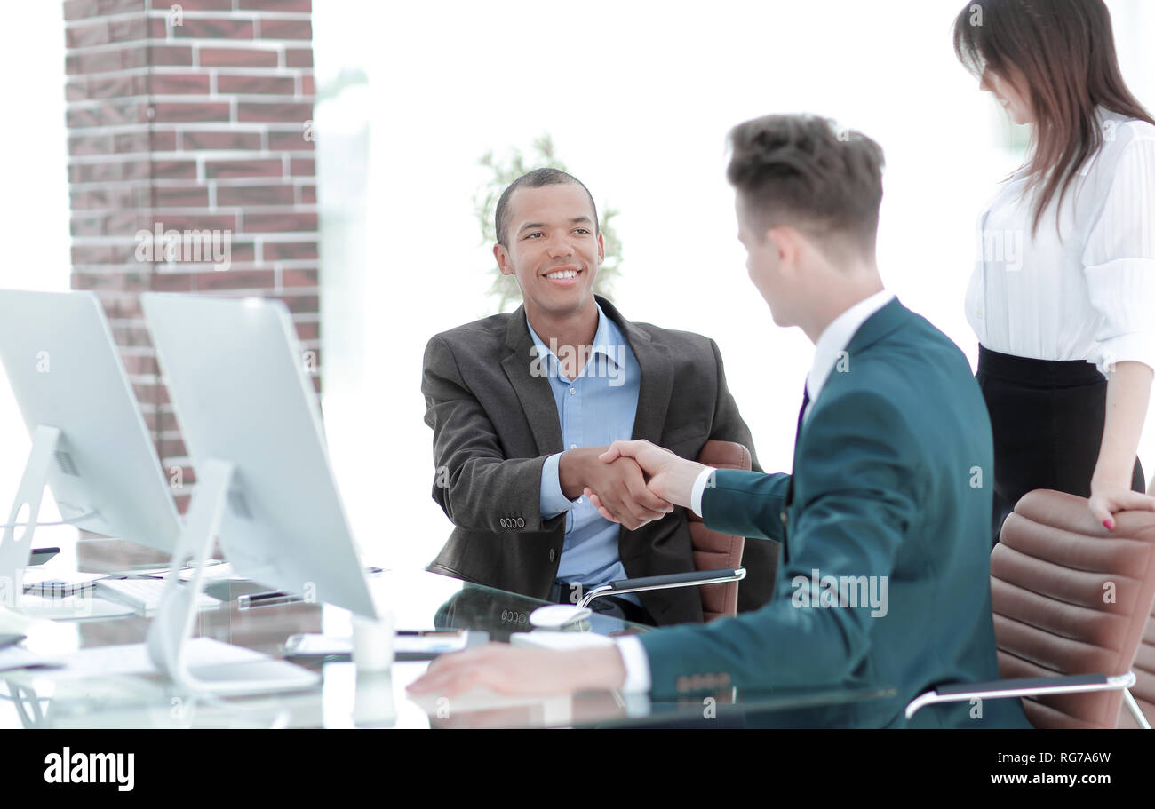 handshake business people behind a Desk in the office Stock Photo - Alamy