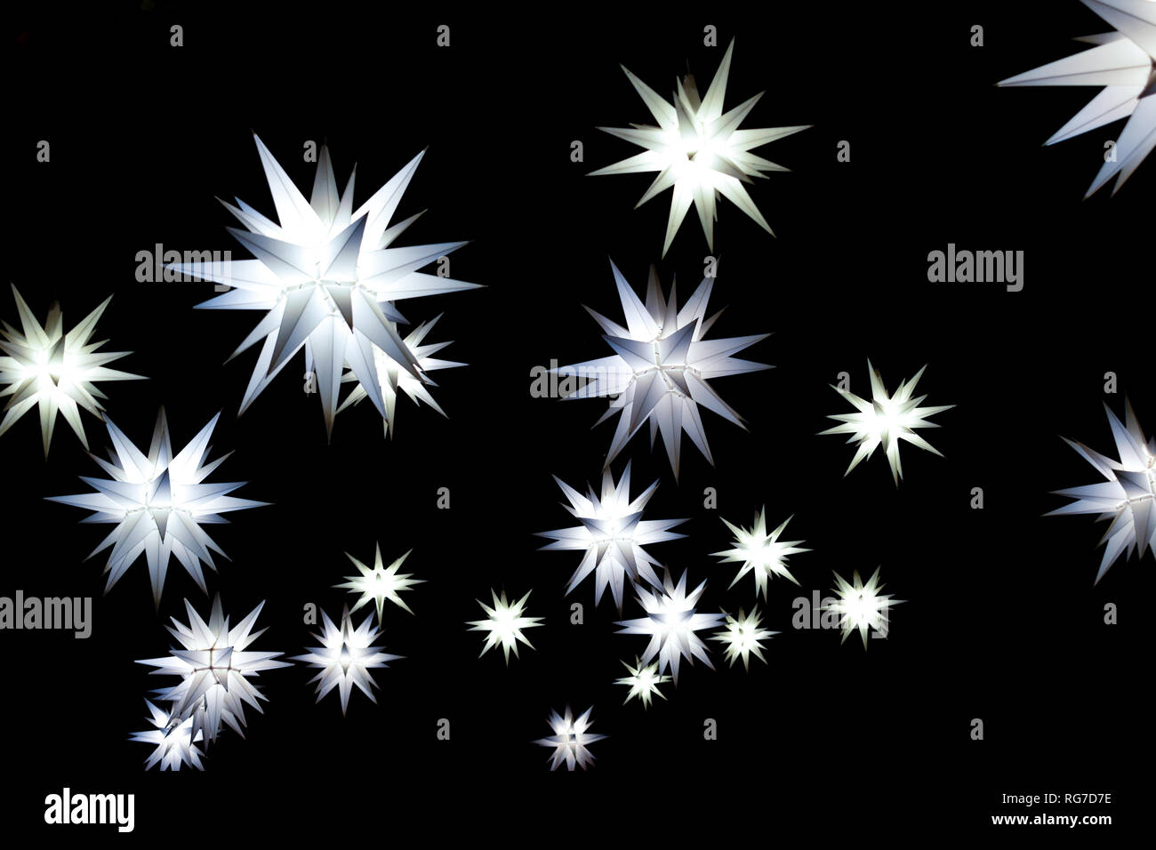 Abstract background texture with white shining stars on a black ...