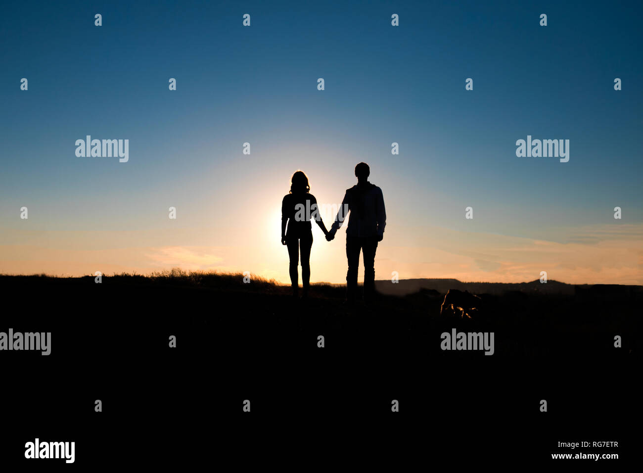 Romantic couple hug at sunset on background Stock Photo - Alamy