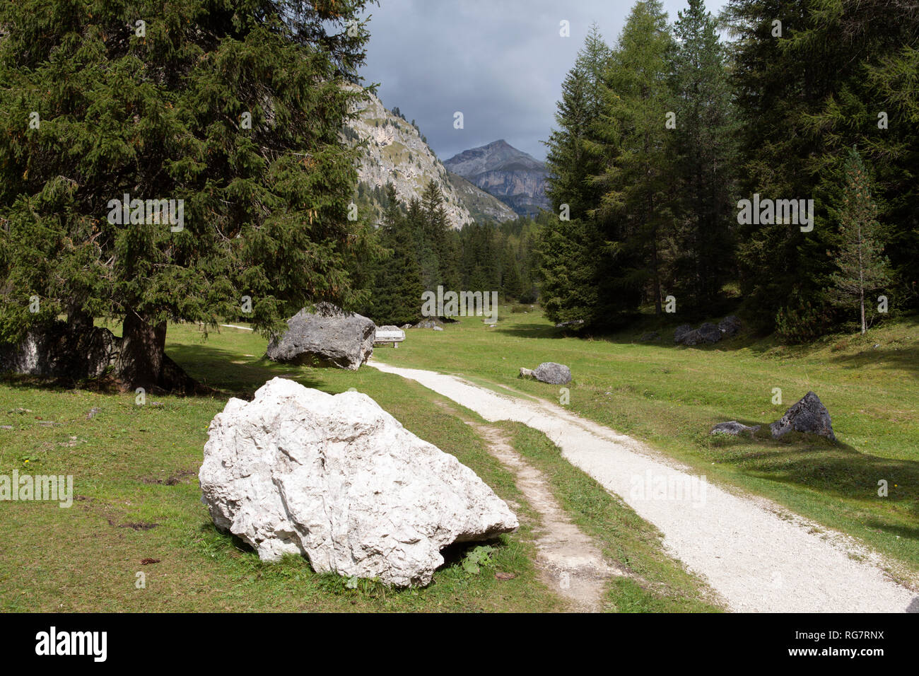 Walkway, trail through a rocky landscape towards high ranges, alps ...