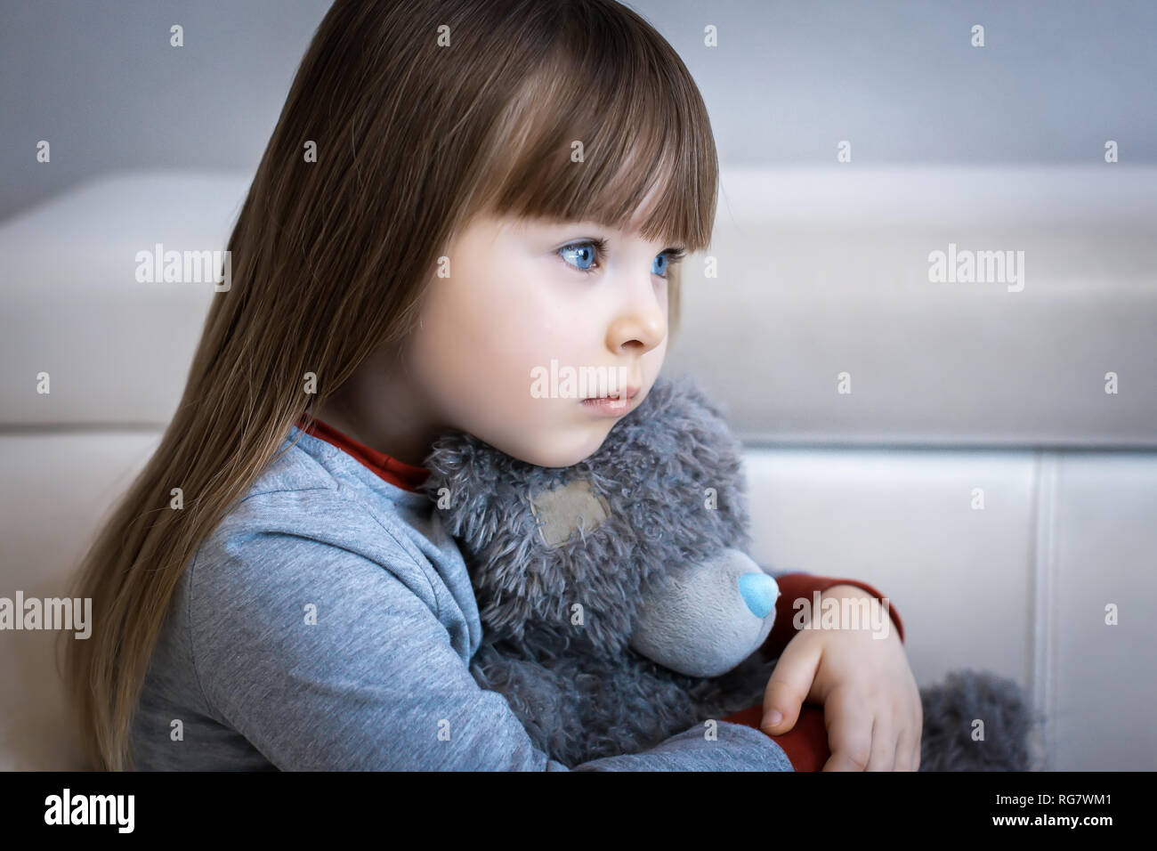 Portrait of little girl. Kid sad face sitting alone in the room Stock ...
