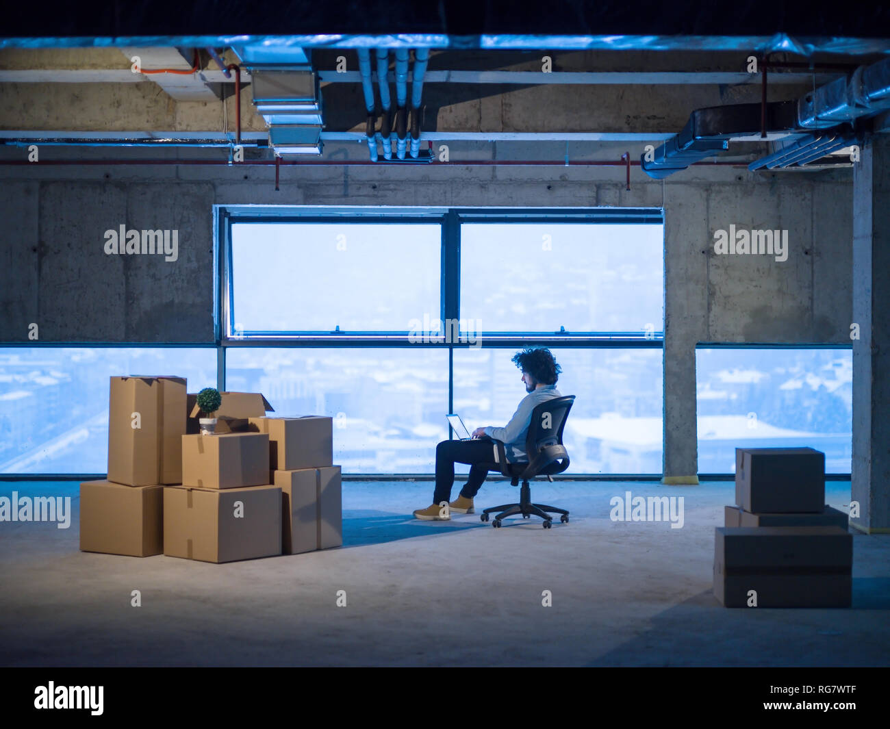 young male architect on construction site checking documents and ...