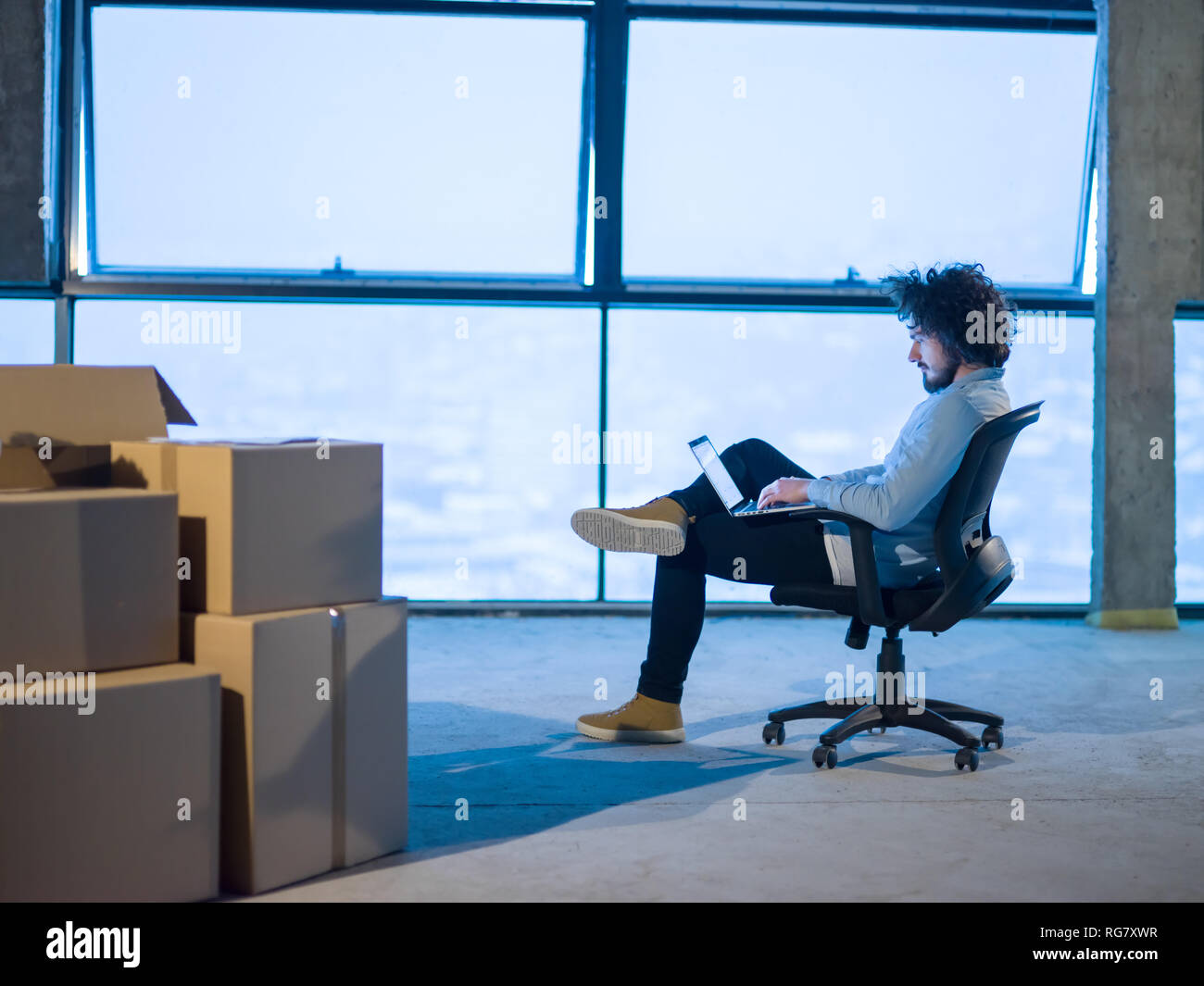 young male architect on construction site checking documents and ...