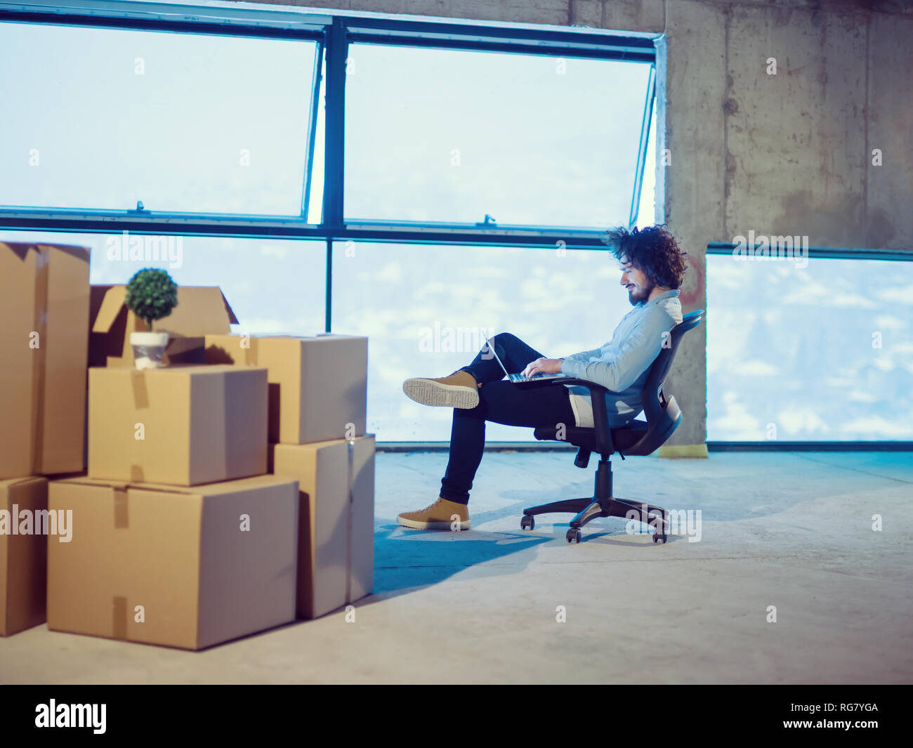 young male architect on construction site checking documents and ...
