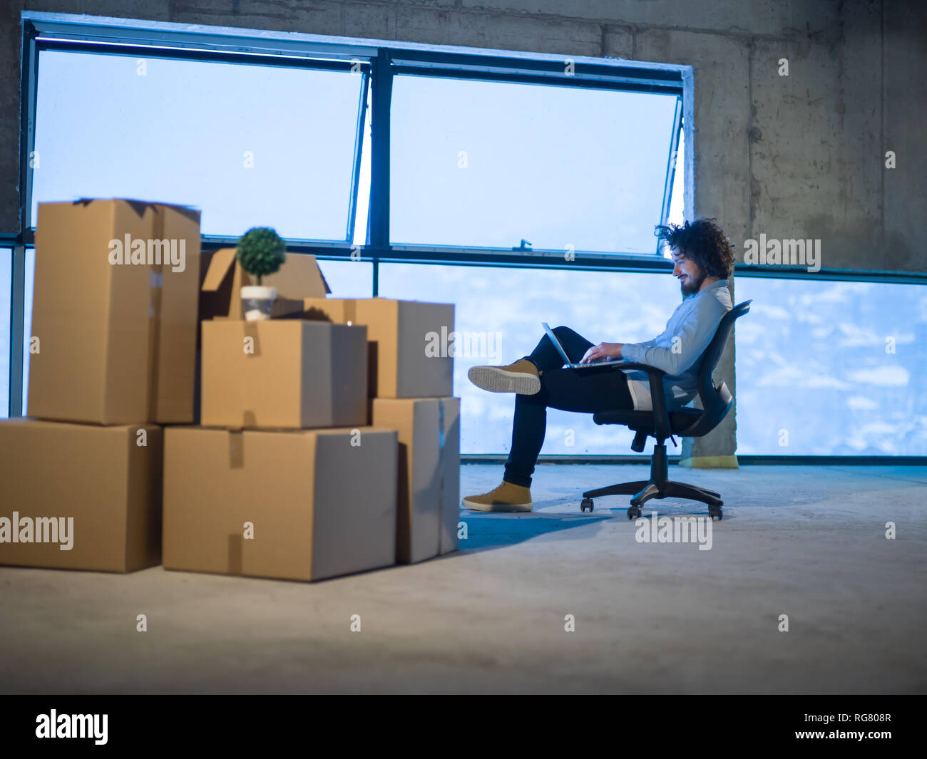 young male architect on construction site checking documents and ...