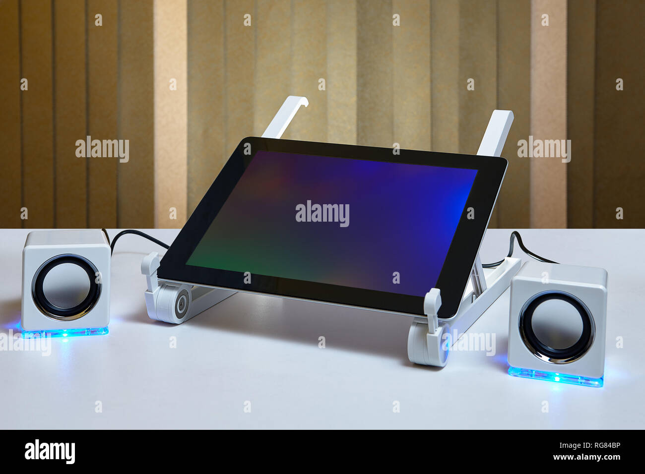 Tablet PC is connected to small external speakers Stock Photo - Alamy