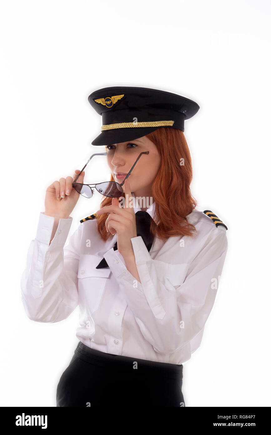 Young female pilot with red hair standing in airline uniform including ...