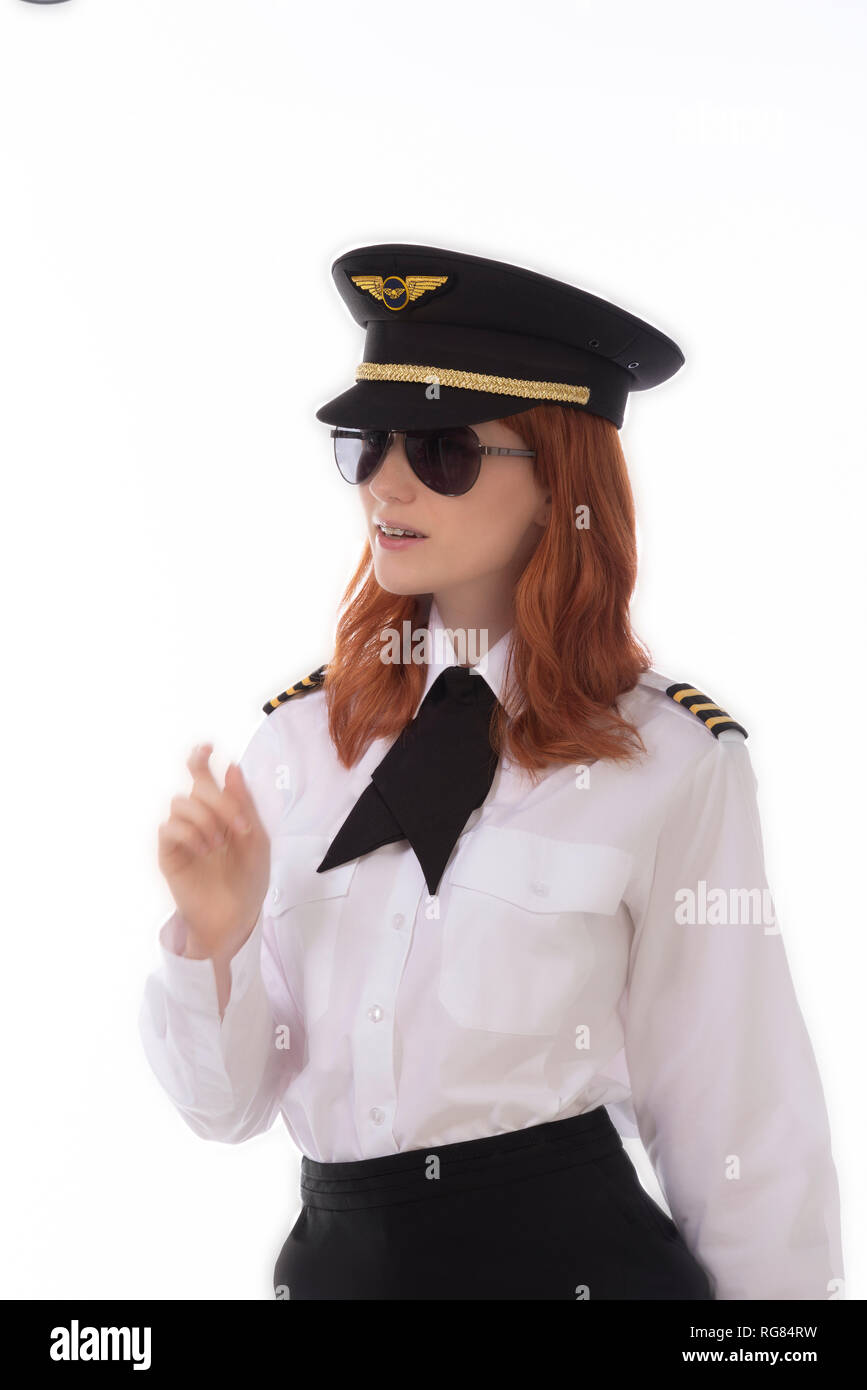 Young female pilot with red hair standing in airline uniform including ...