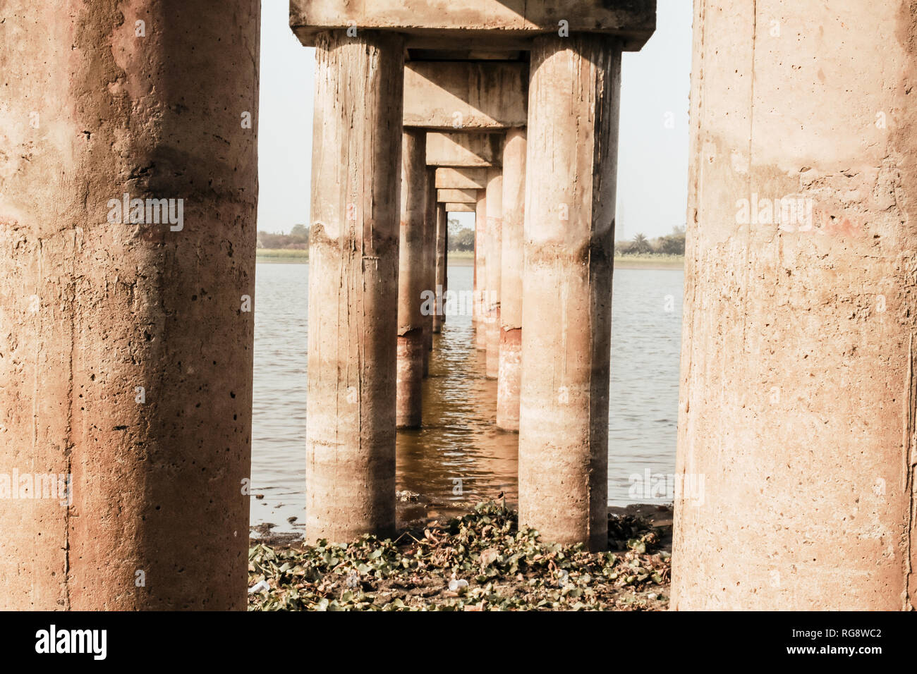 A river bridge under construction, pillars of urban architecture of ...