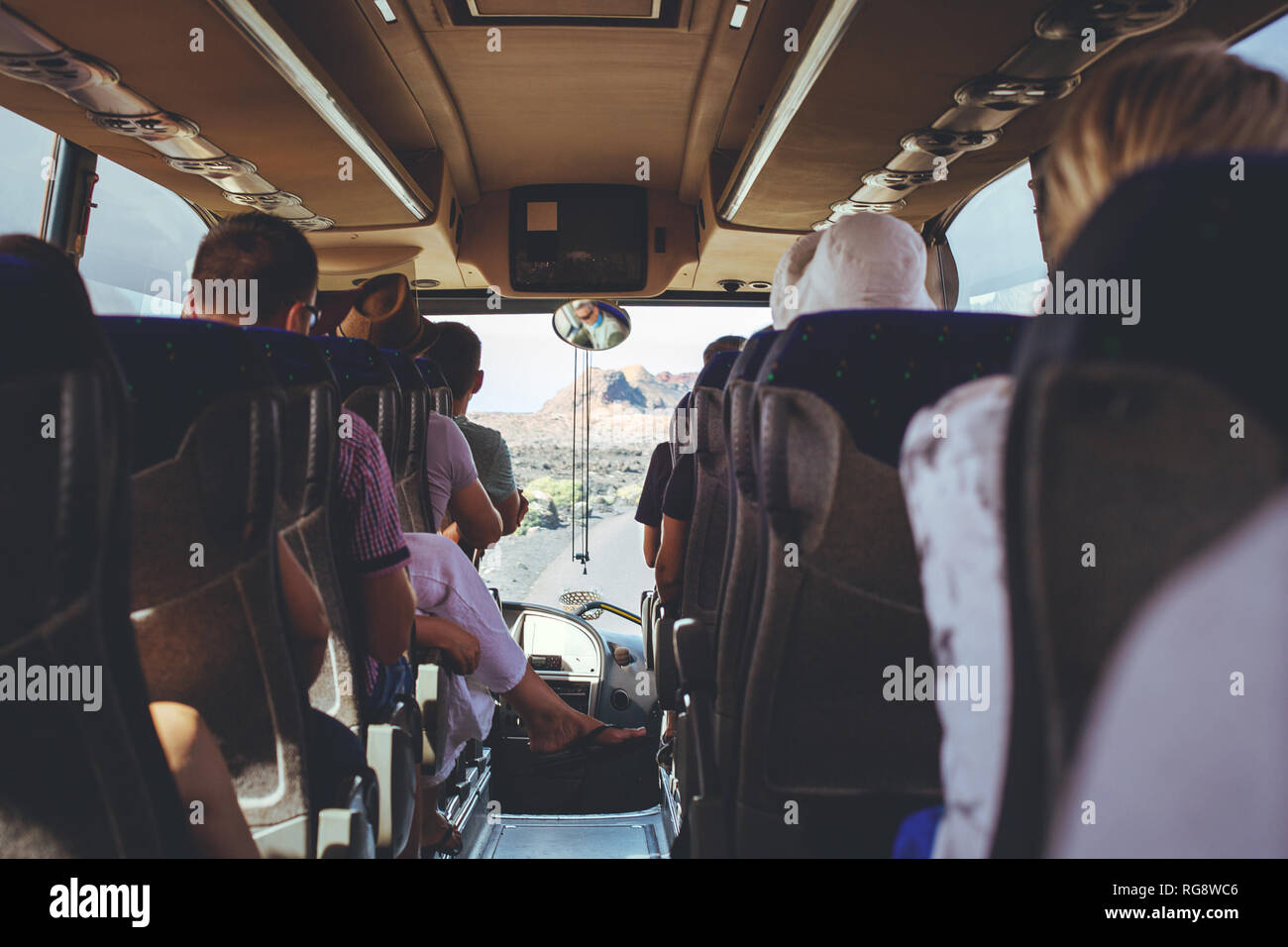 The tourist bus interior with people sitting. Back view Stock Photo - Alamy