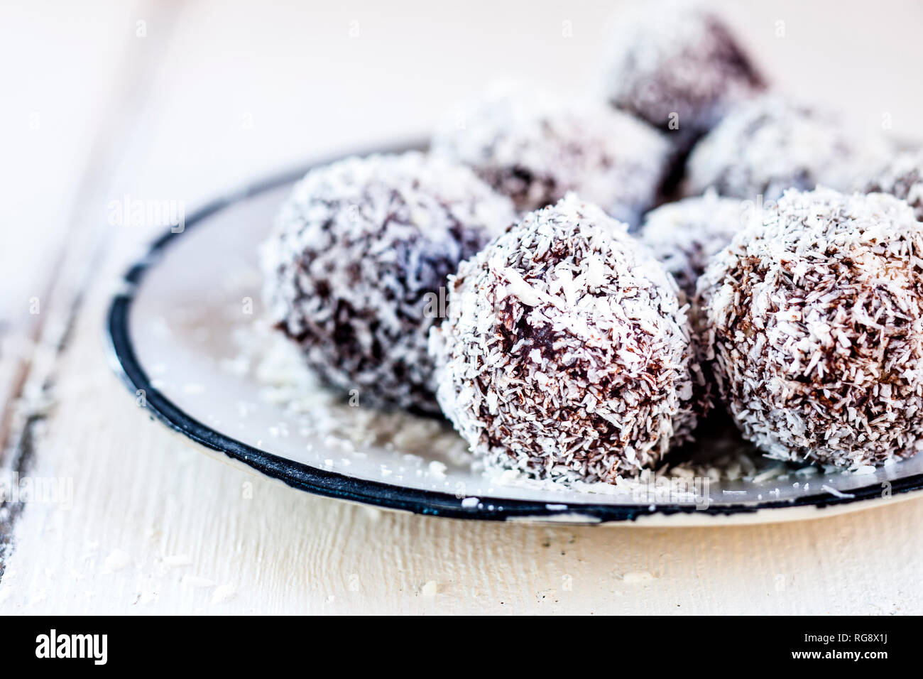 Lamington bliss balls with cashews, filled with raspberries, dark ...