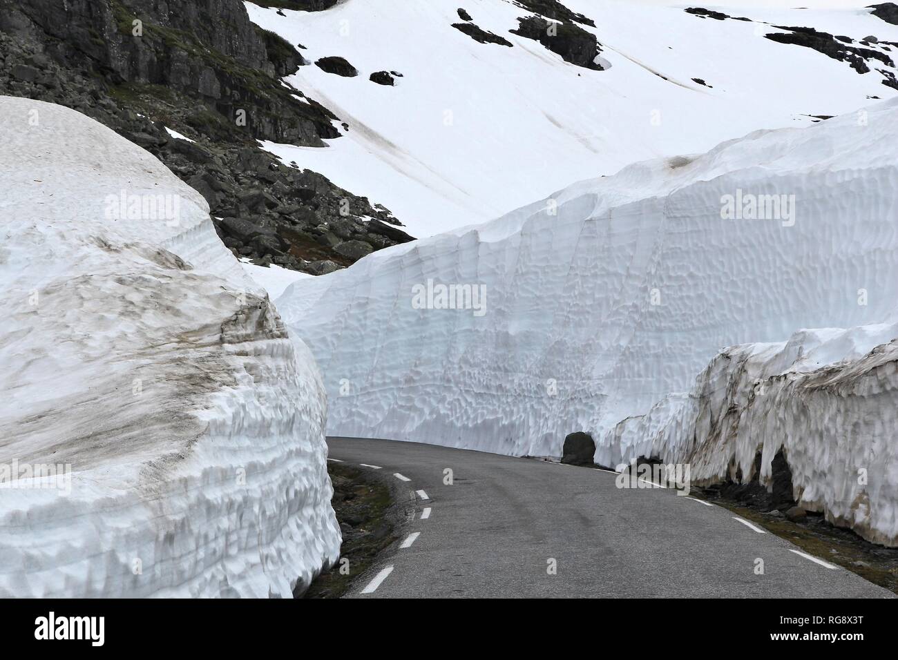 Snow road maintenance - snowy walls and dry road in Norway ...