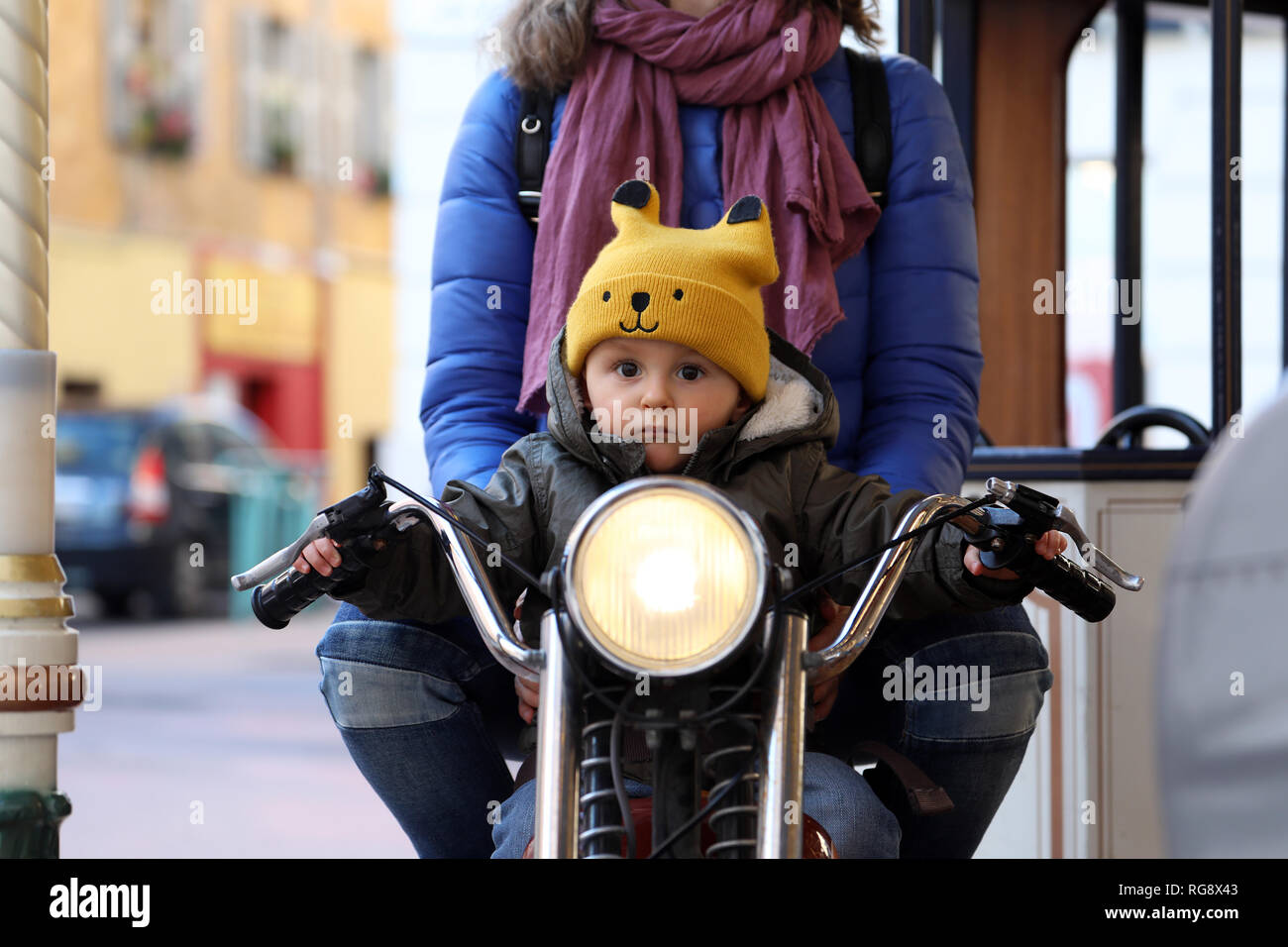 Cute Baby Boy Sitting On A Vintage Motorcycle With His Mom, The Little ...