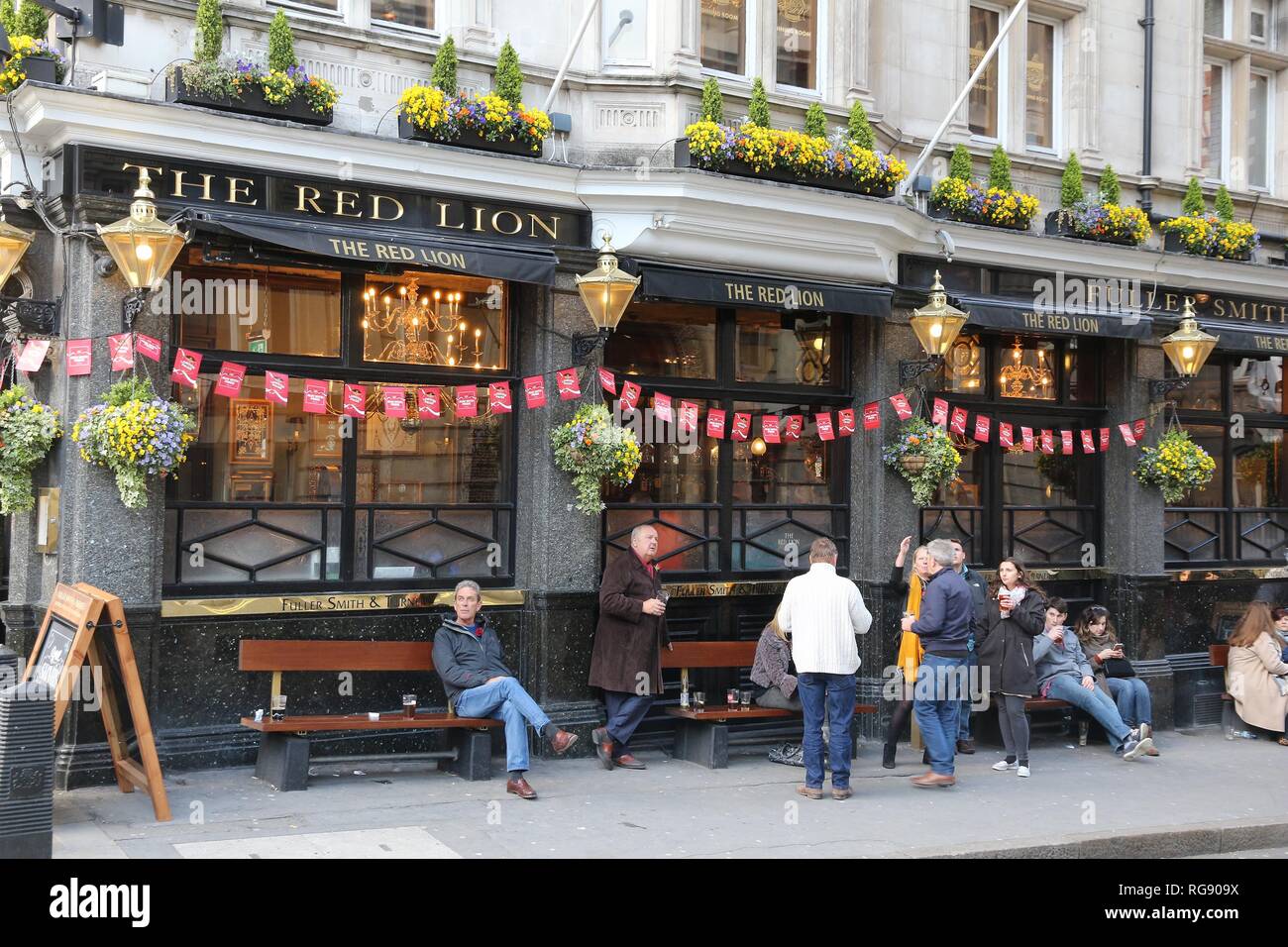 LONDON, UK - APRIL 23, 2012: People visit The Red Lion pub in London ...