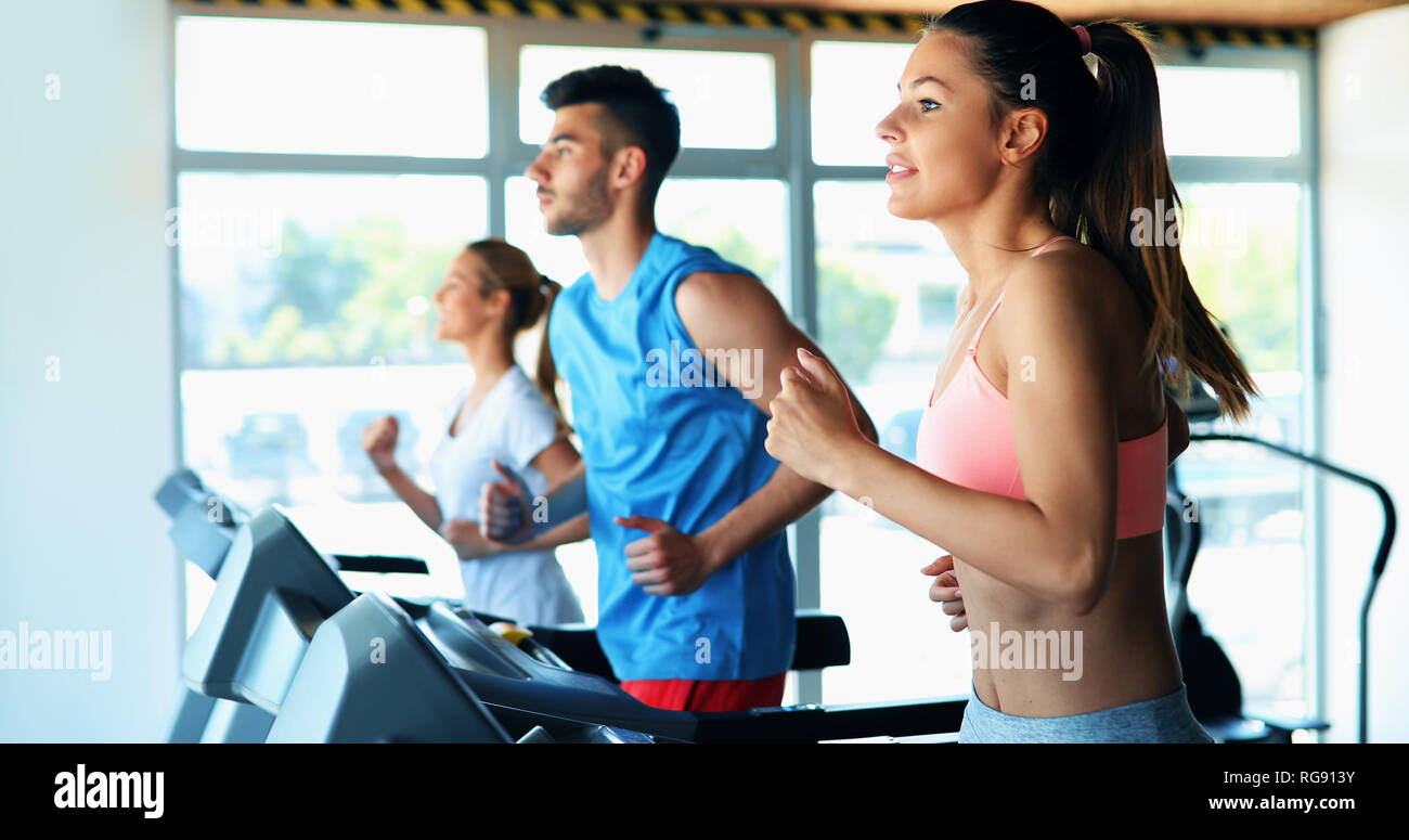 Group of friends exercising on treadmill machine Stock Photo - Alamy