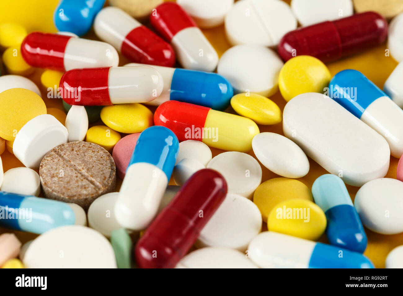 Multi-colored tablets are scattered as a background. space for text ...