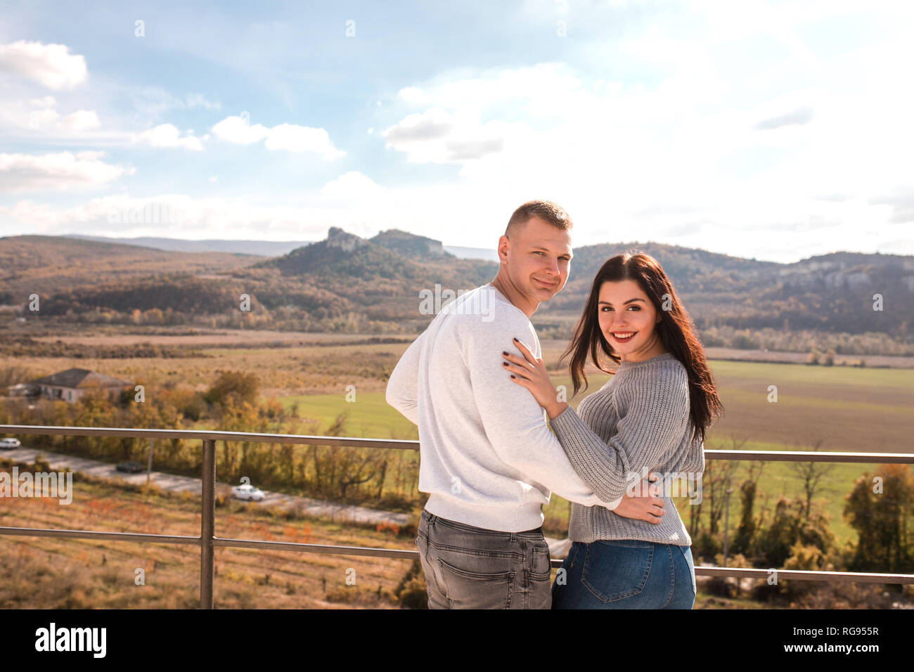 Romantic young couple hugging and smiling outdoors Stock Photo - Alamy