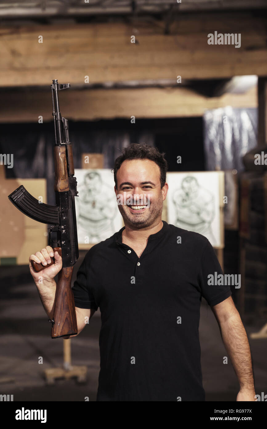 Man holding rifle hi-res stock photography and images - Alamy
