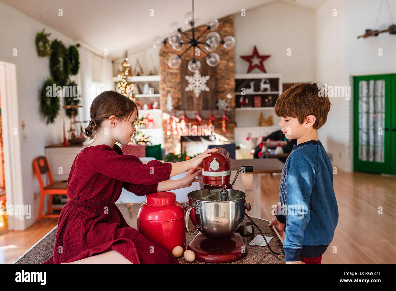 Two children in the kitchen making a cake Stock Photo - Alamy