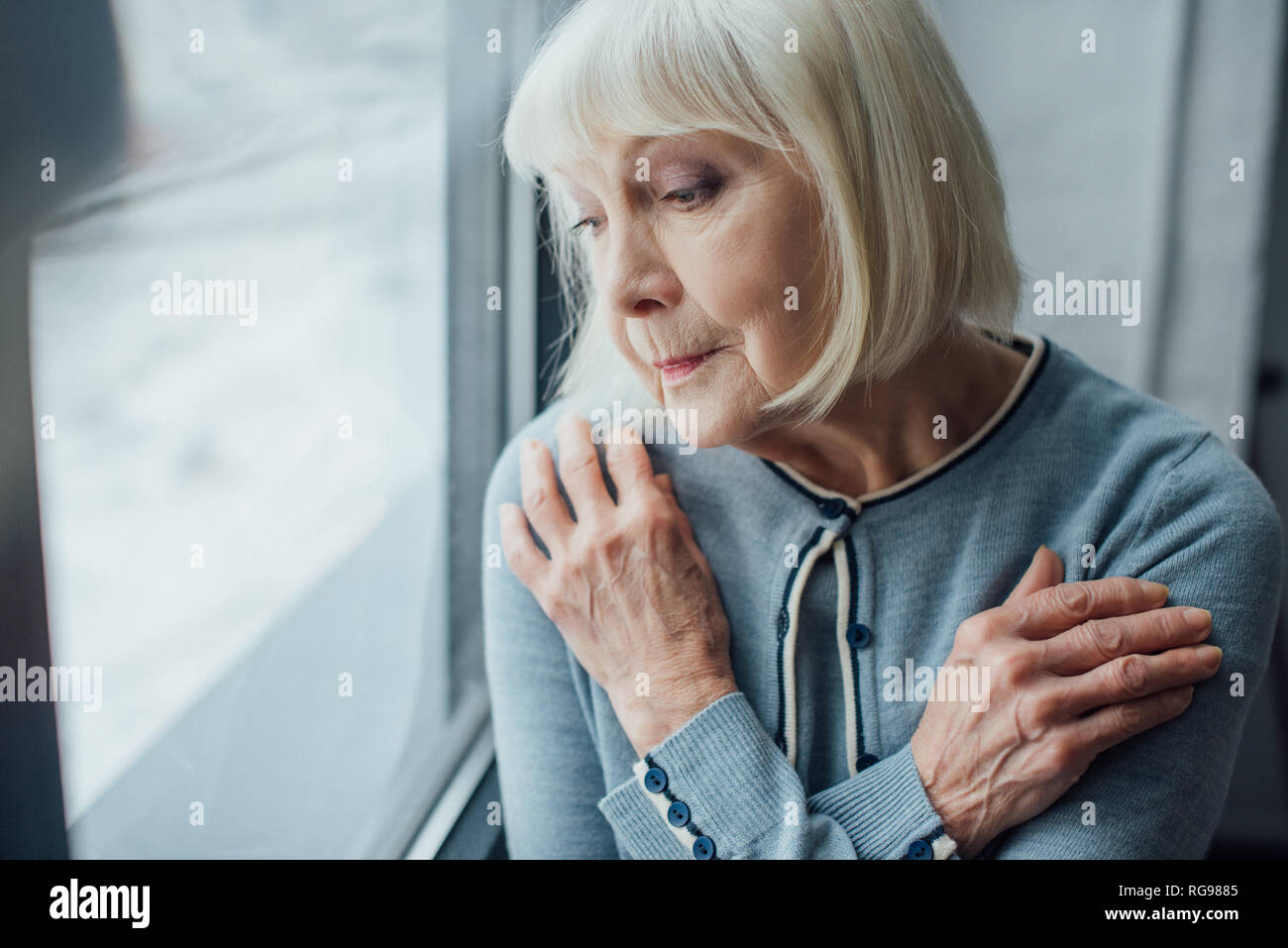 Old person sad window female hi-res stock photography and images - Alamy
