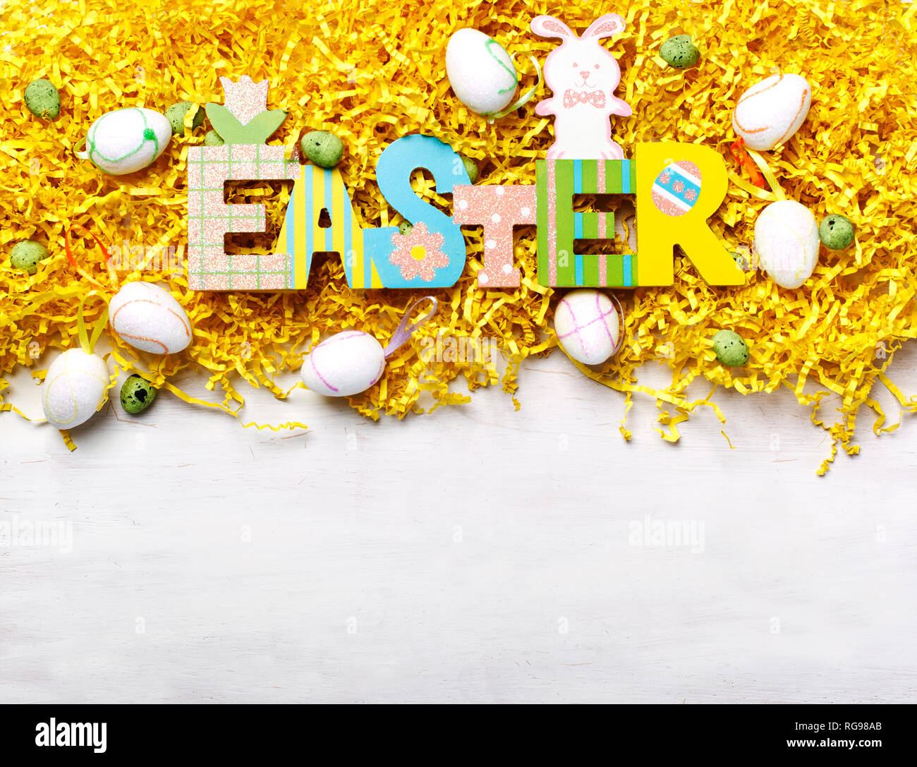 Word Easter and Easter eggs on shredded paper Stock Photo - Alamy