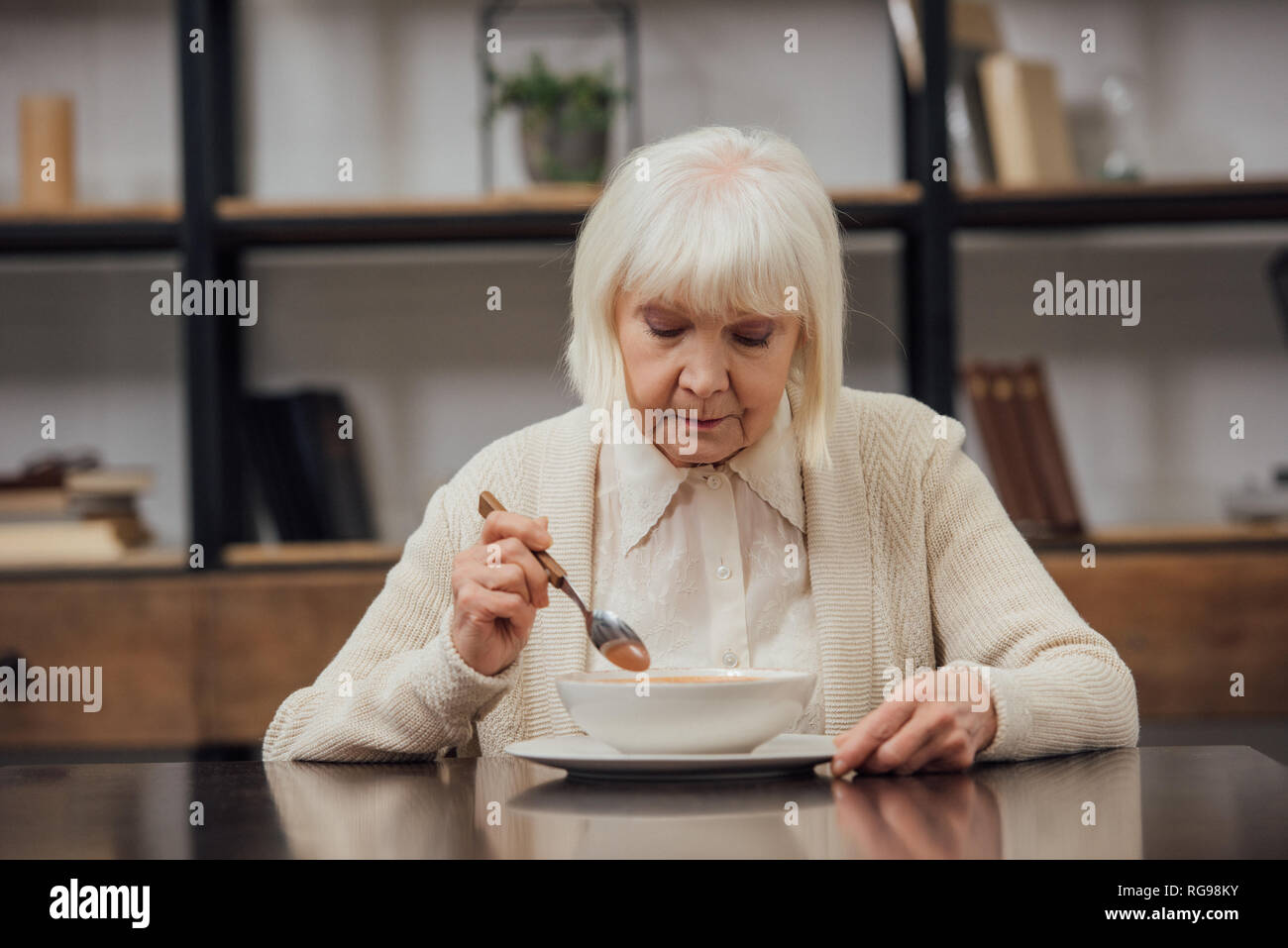 Old woman table sad hi-res stock photography and images - Alamy