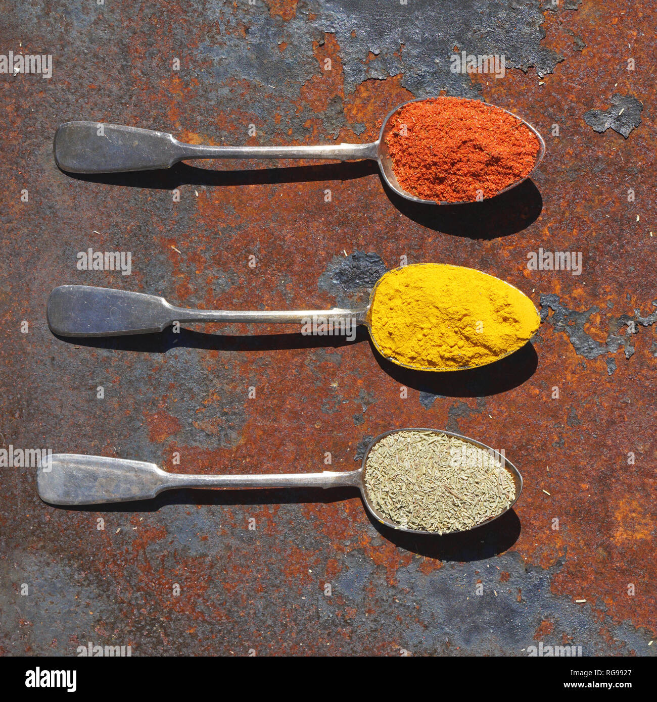 an assortment of different spices for cooking in silver spoon . Red ...