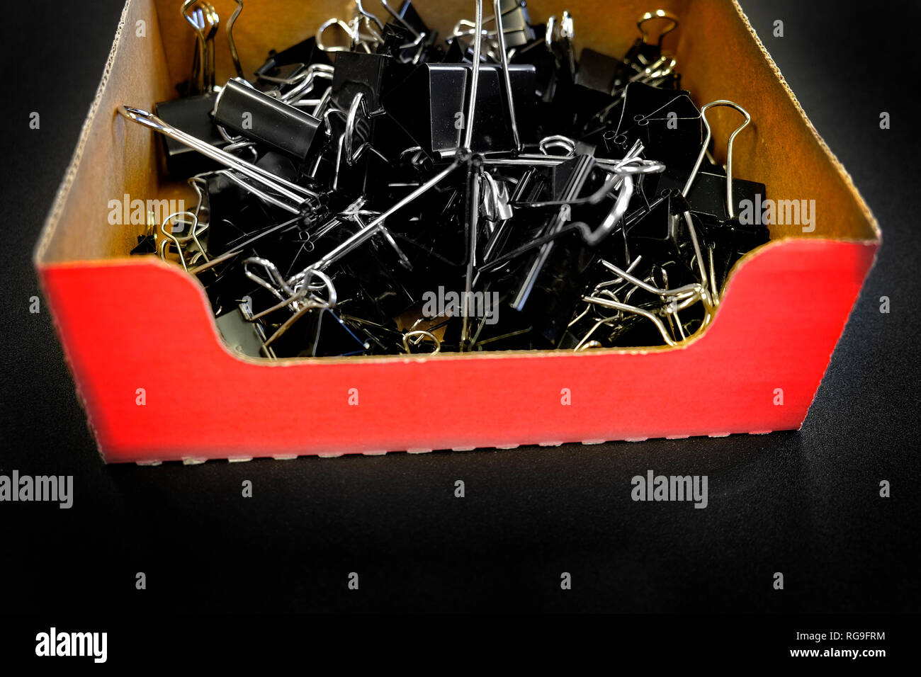 Box of binder clips binderclips office supplies of paperclips on desk ...