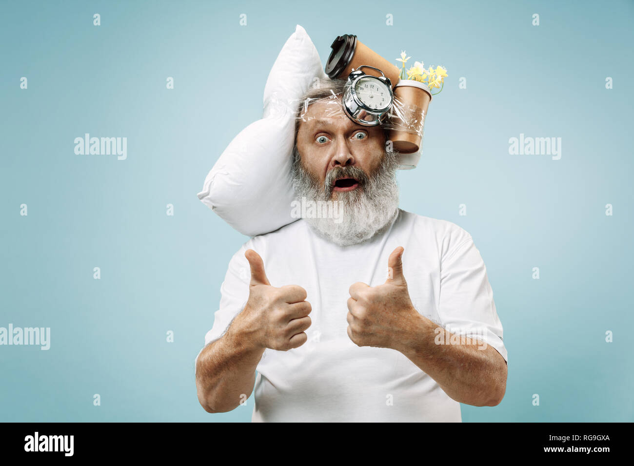 Surprised senior man screaming after sleeping at home or office having ...