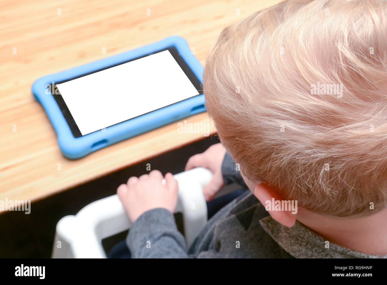 Child using a tablet device to learn and play games, model is young boy ...